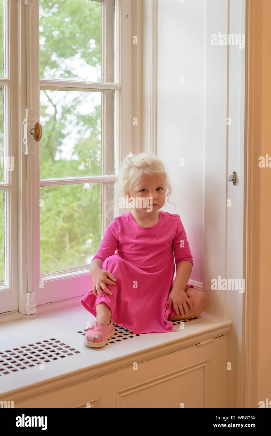 Child Sitting On Window Sill High Resolution Stock Photography and ...
