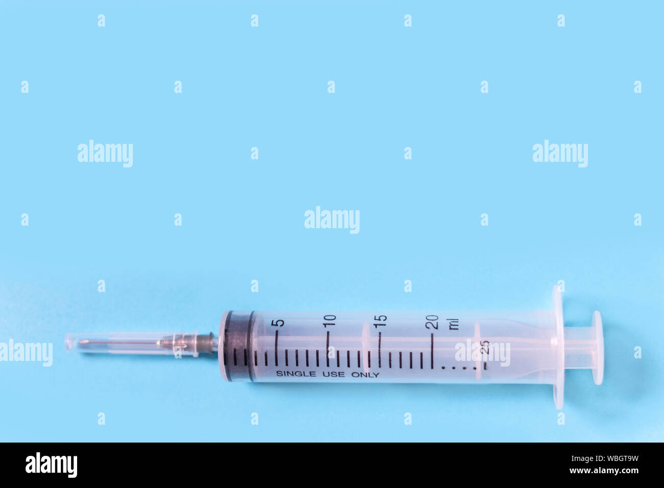 Syringe or injection needle on blue background. Top view syringes copy ...