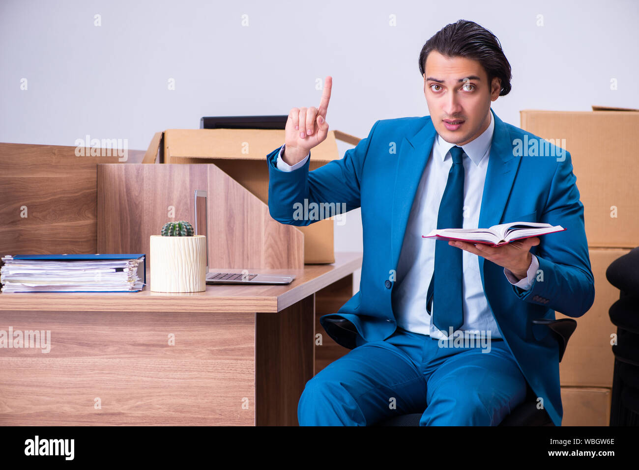 The young handsome businessman being fired from his work Stock Photo ...