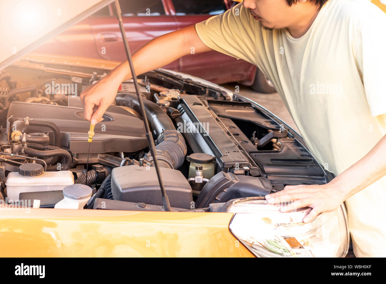 Automotive mechanic checking and repair car in garage Stock Photo - Alamy