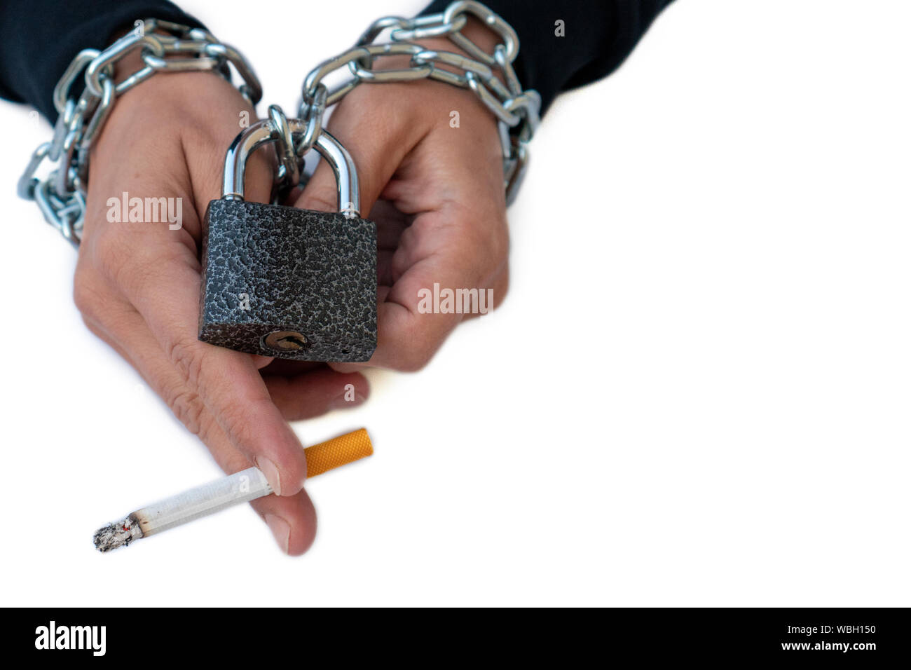 Woman's hands tied by chain and lock with cigarette on a white ...