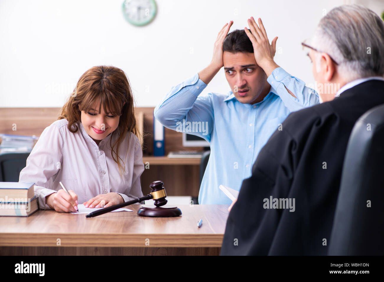 The young couple in the courthouse in divorce concept Stock Photo - Alamy