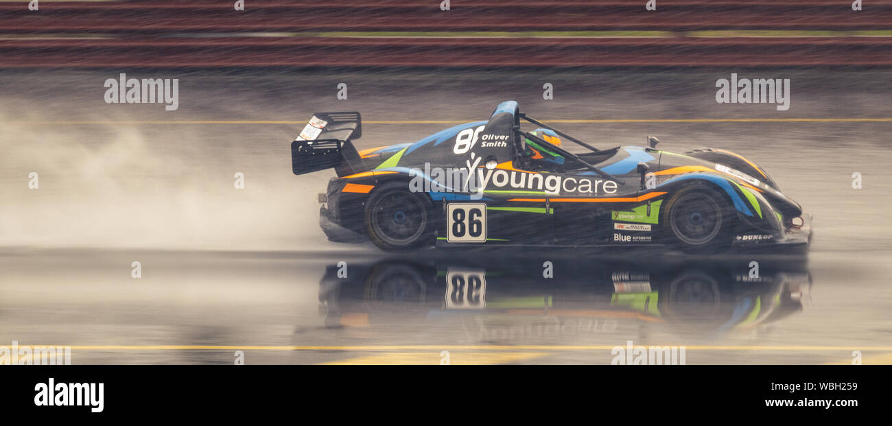 A Radical Racecar driving in heavy rain and wet conditions with a ...