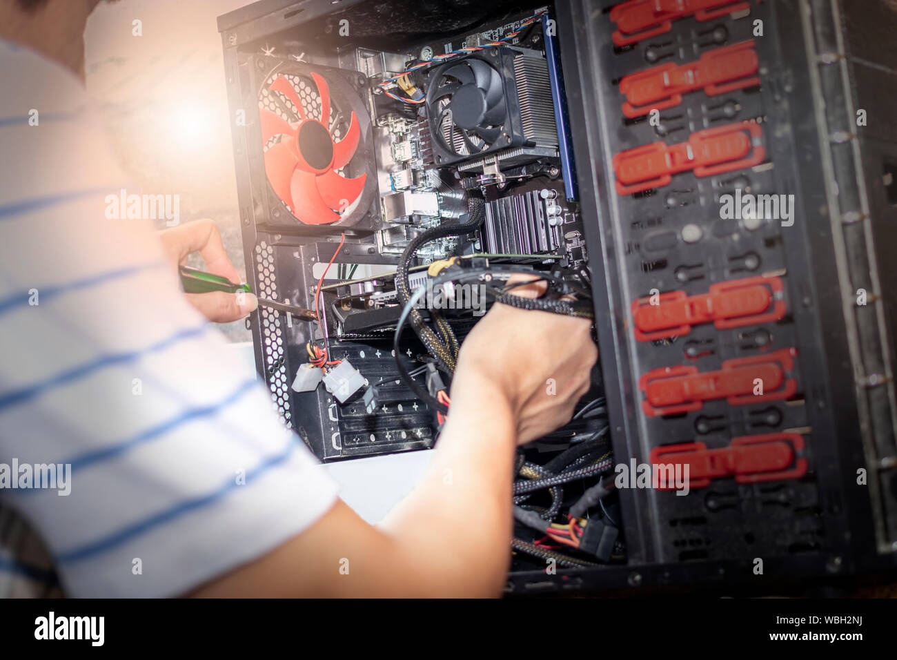 Young man hand holding the screwdriver for repairing the computer. The ...