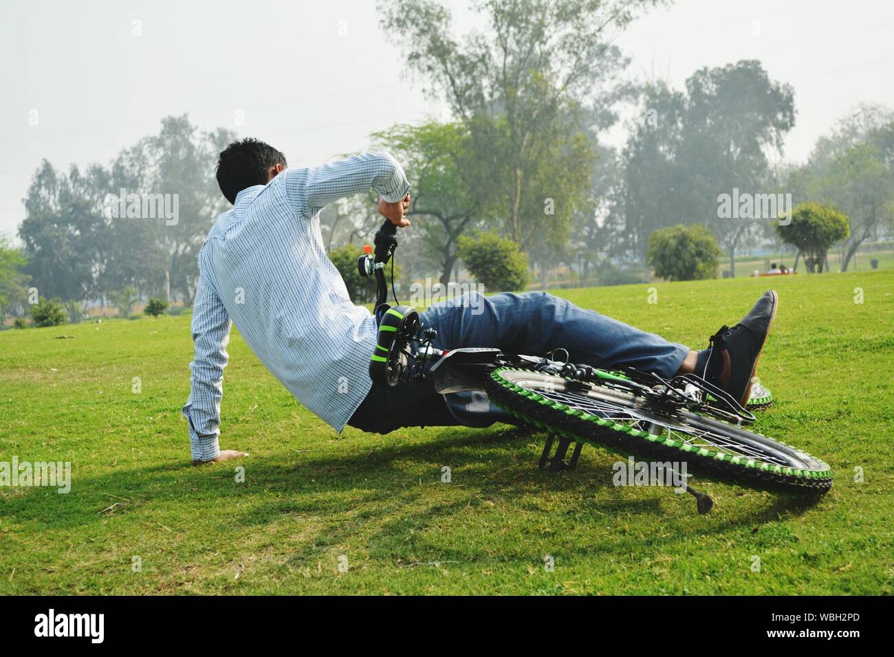 Young man falling from bicycle hi-res stock photography and images - Alamy