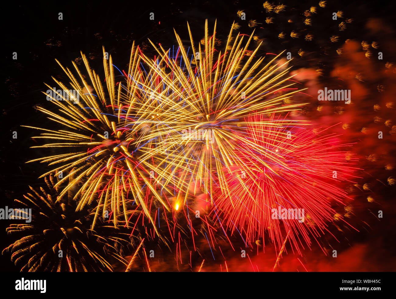Colorful fireworks in night sky background Stock Photo - Alamy