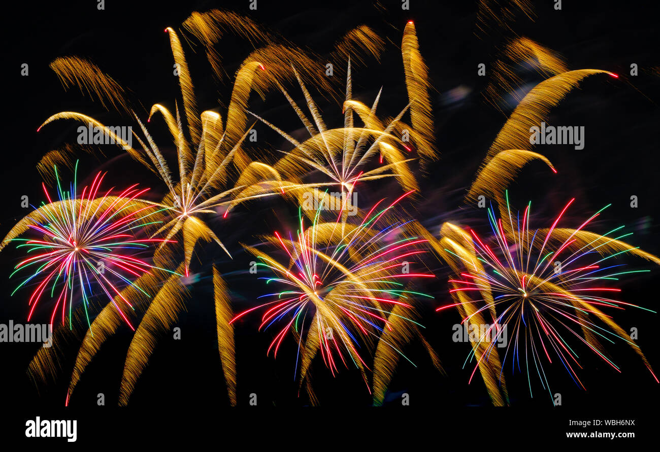 Colorful fireworks in night sky background Stock Photo - Alamy