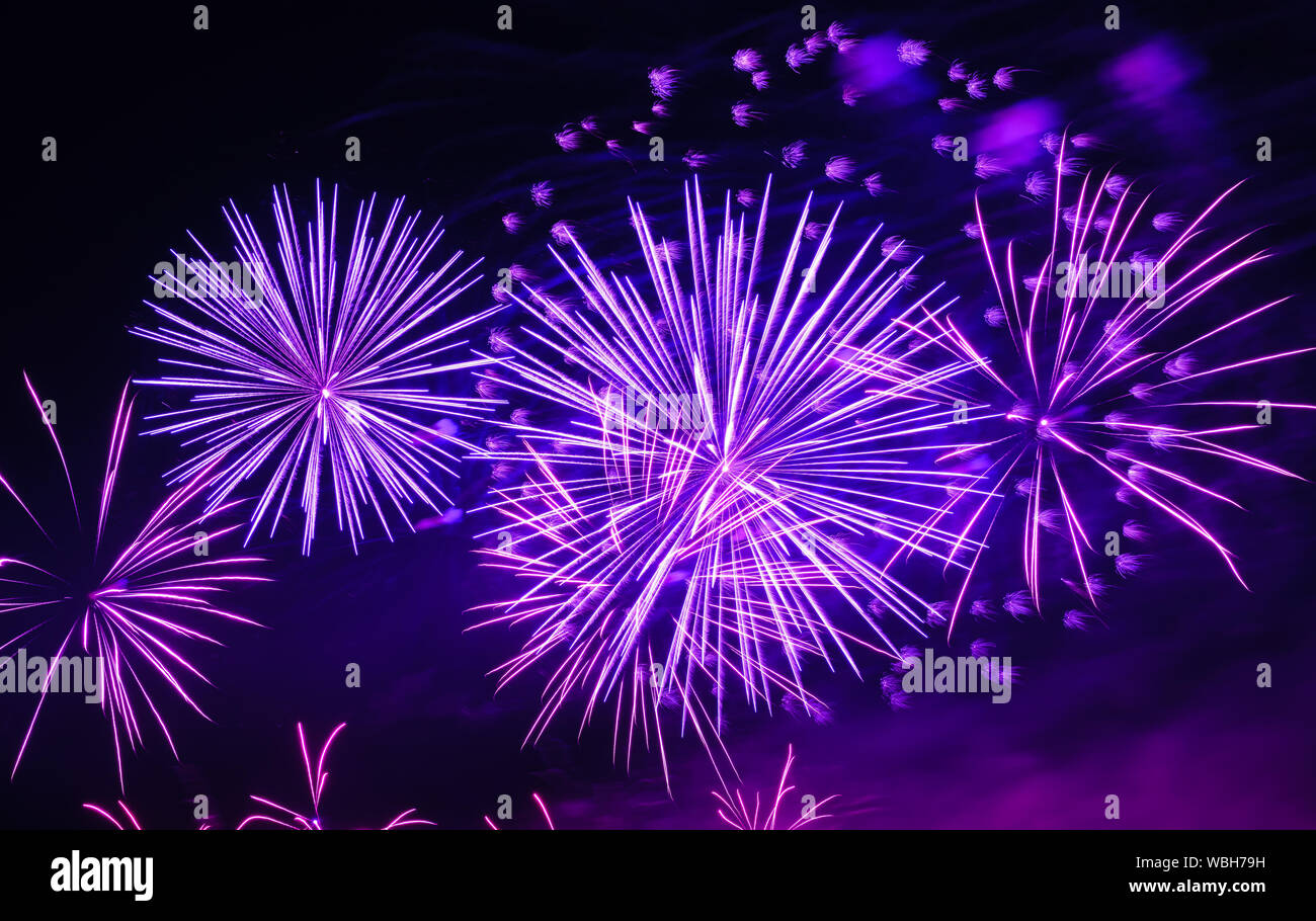 Colorful fireworks in night sky background Stock Photo - Alamy