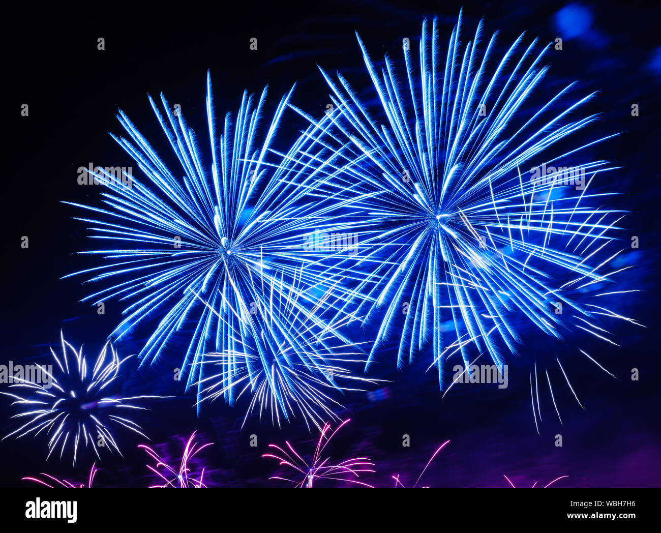 Colorful fireworks in night sky background Stock Photo - Alamy