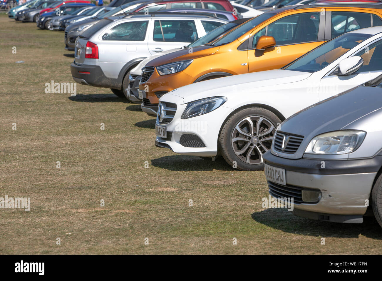 Cars parked in a field at a village fete Stock Photo - Alamy