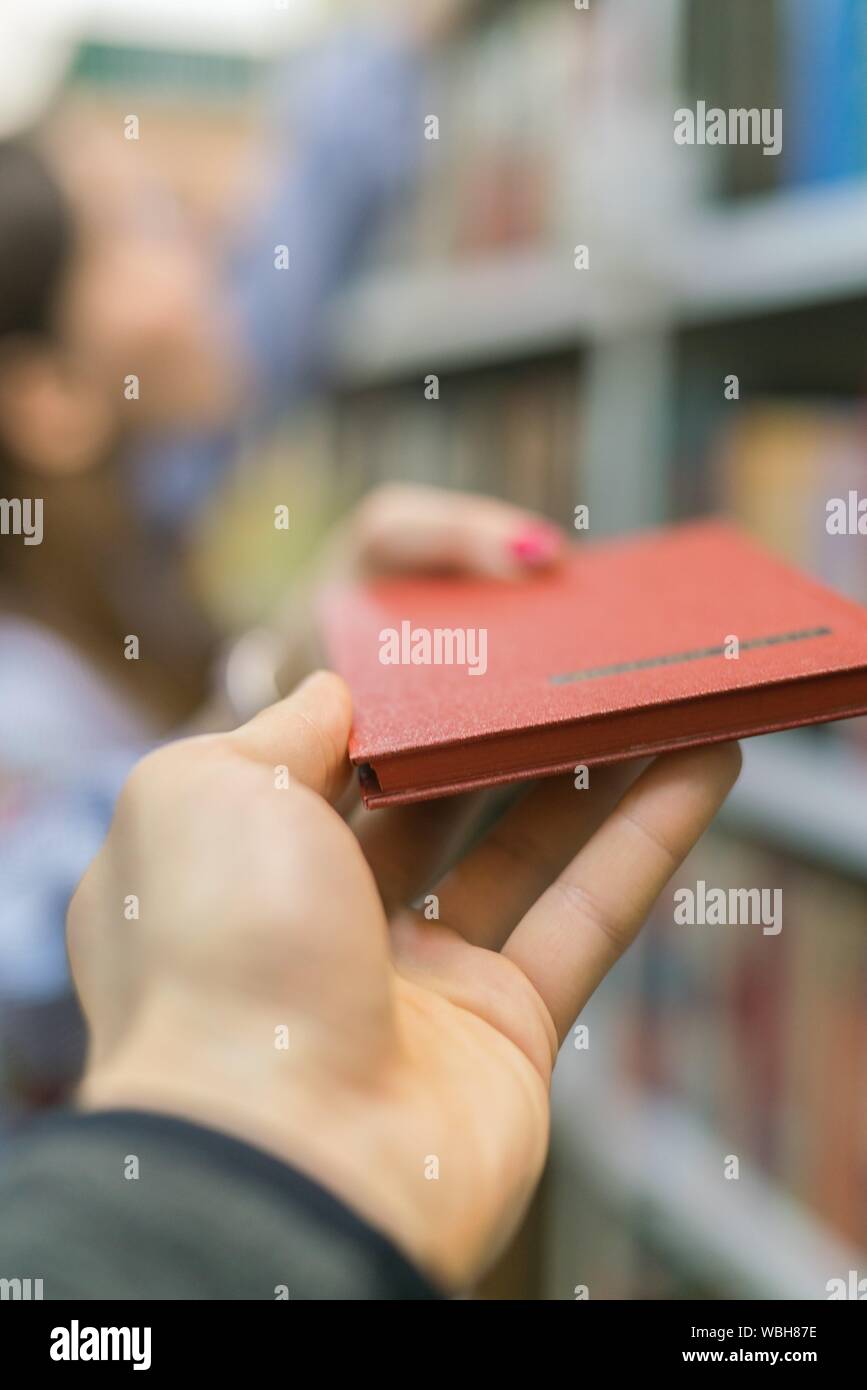 Hands holding book hi-res stock photography and images - Alamy