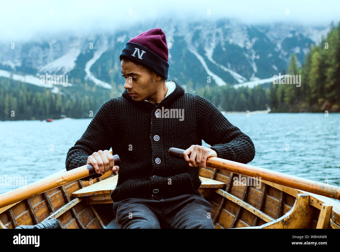 Young men rowing boat hi-res stock photography and images - Alamy