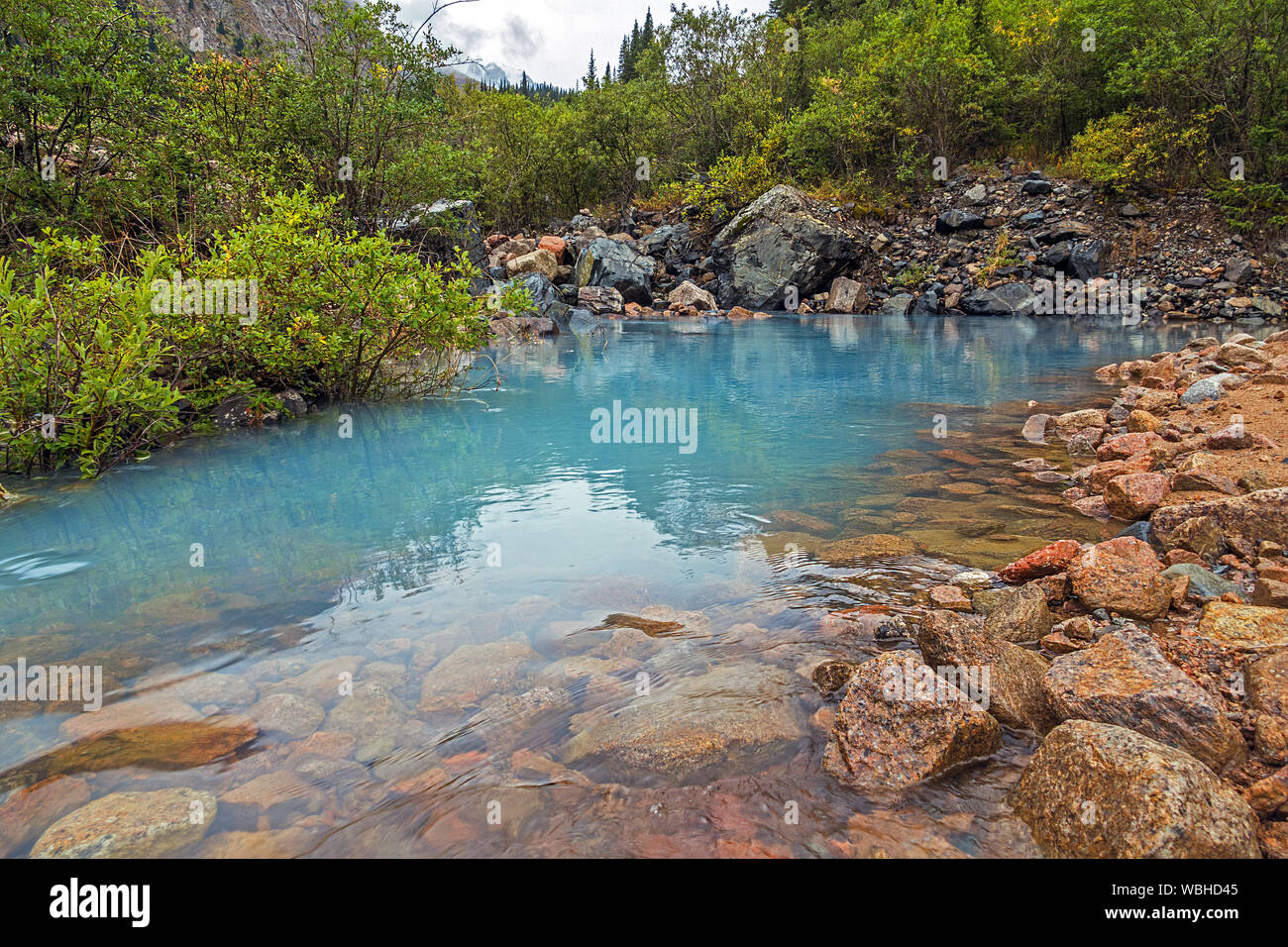 Blue spring in the mountains, source of crystal pure natural water ...