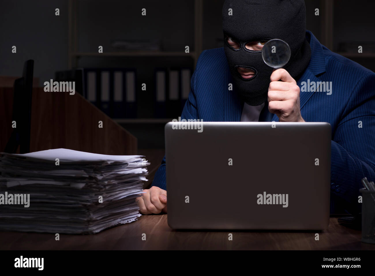 The male employee stealing information in the office night time Stock ...