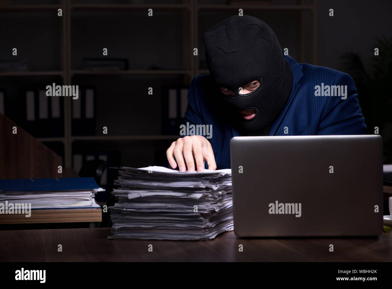 The male employee stealing information in the office night time Stock ...