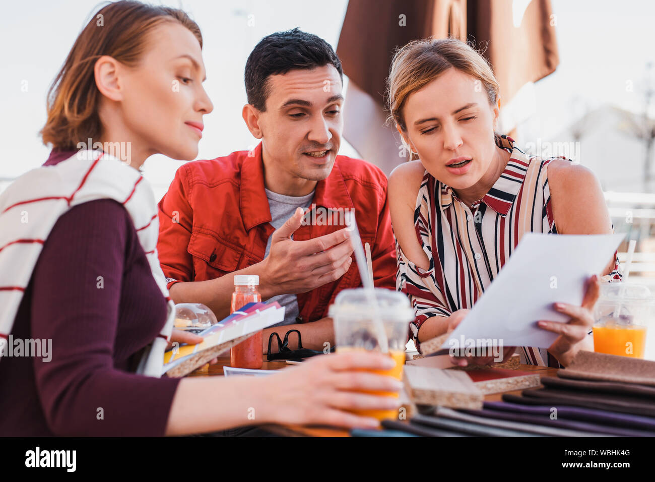 Partners discussing new project out of office Stock Photo - Alamy