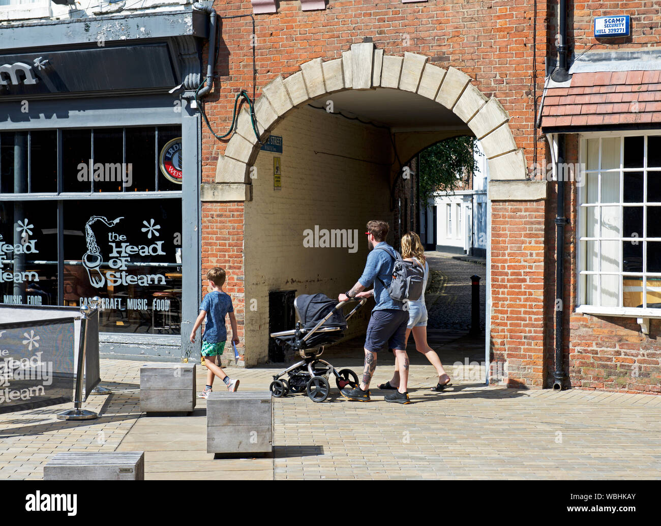 Family walking through Trinity Square, Hull, East Yorkshire, England UK ...