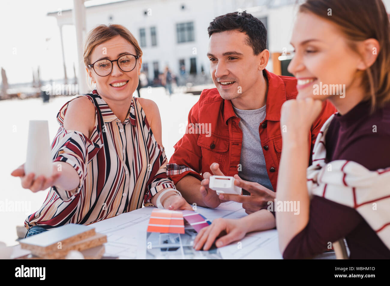 Designers looking at a model of their project Stock Photo - Alamy