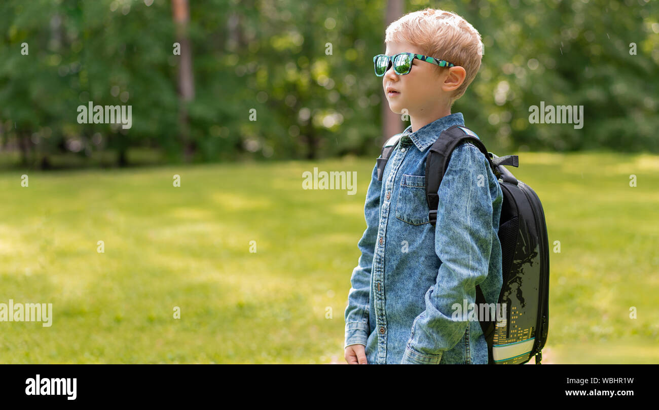 portrait of cute boy with backpack. School. First grader. Outdoor Stock ...