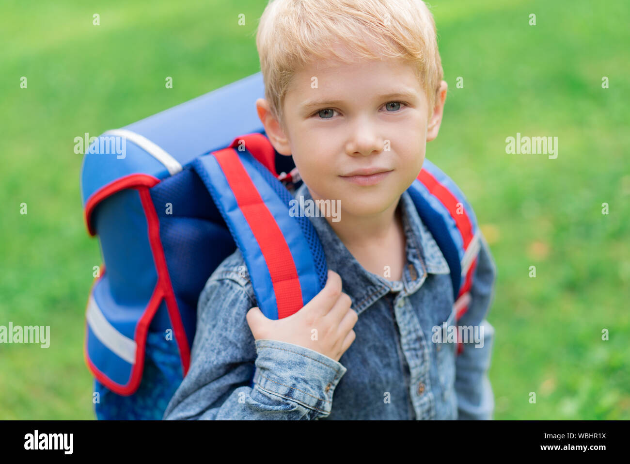portrait of cute boy with backpack. School. First grader. Outdoor Stock ...