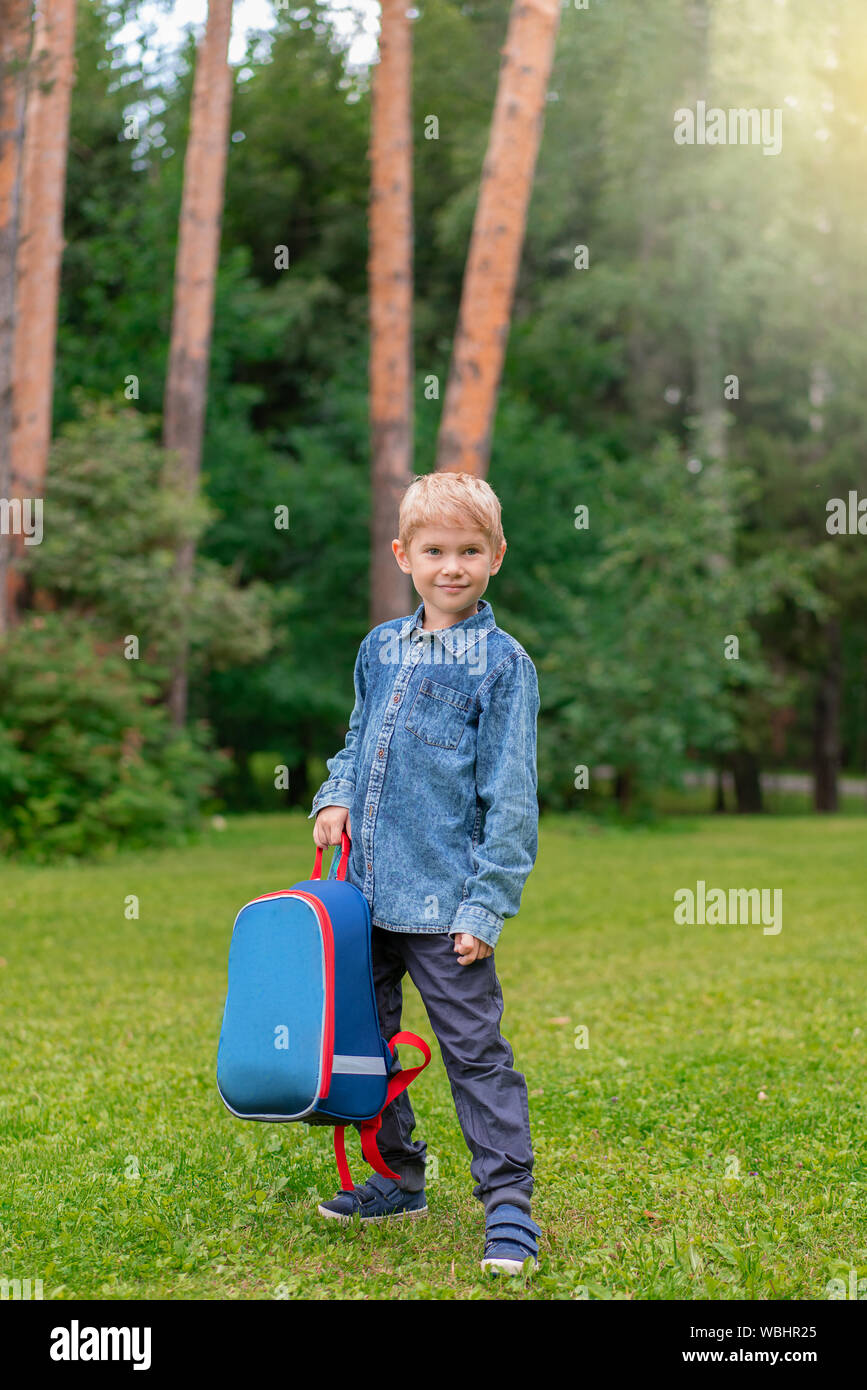 portrait of cute boy with backpack. School. First grader. Outdoor Stock ...