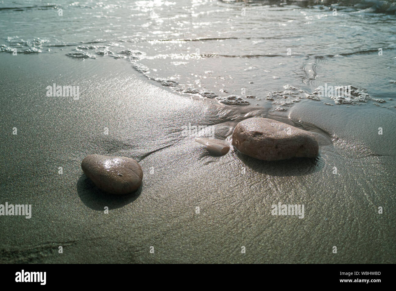 Stones on a beach in Spain Stock Photo - Alamy