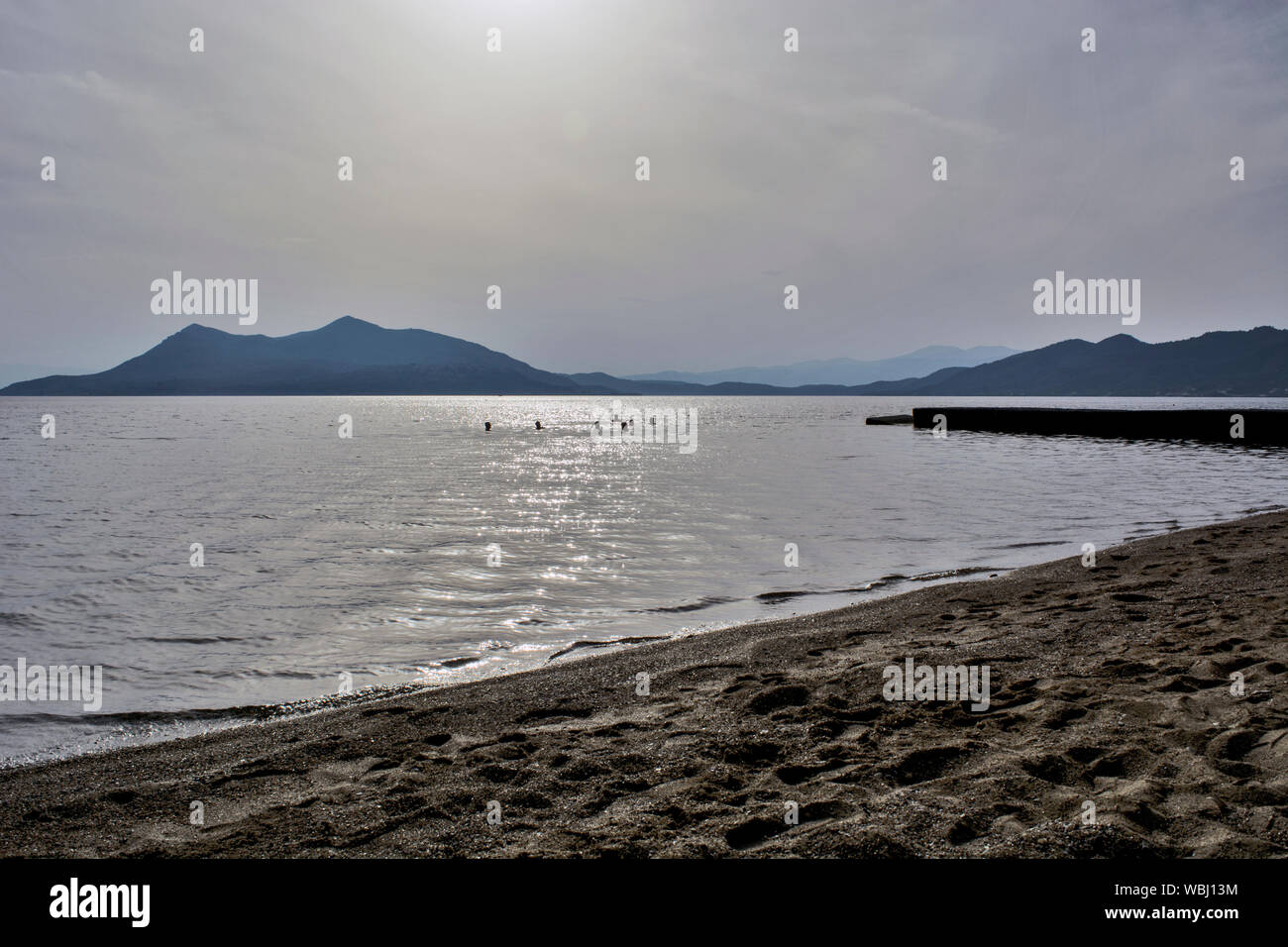 A group of swimmers in Greece bathe in the sea before sunset Stock ...