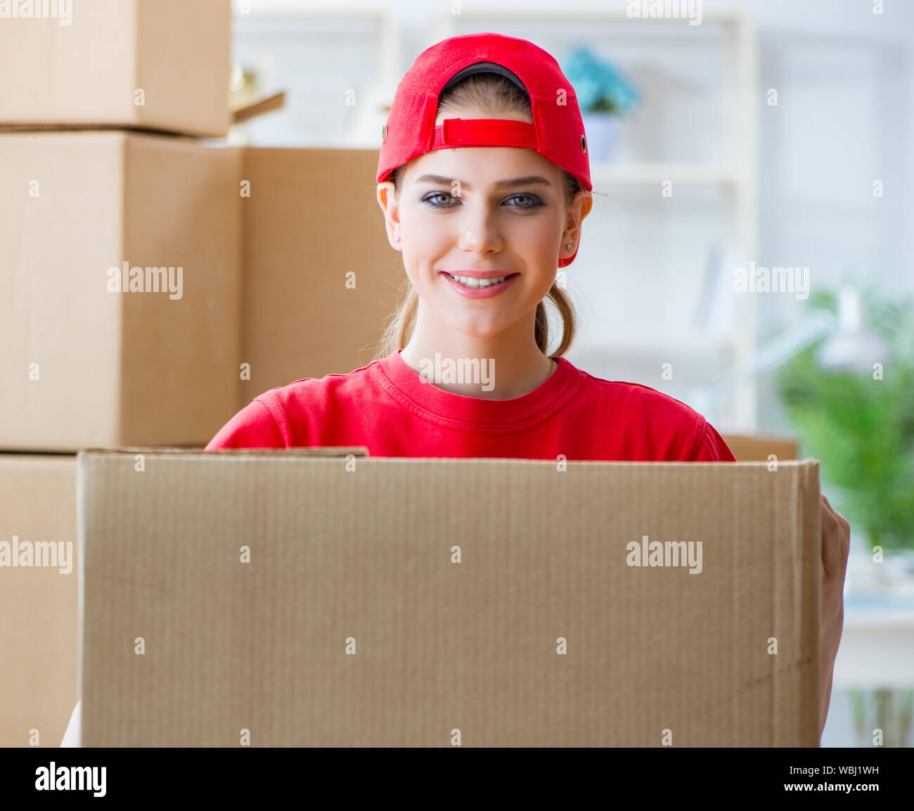 The young woman delivering boxes of personal effects Stock Photo - Alamy