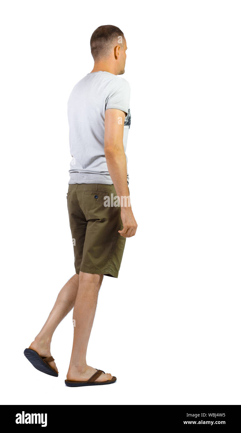 Back view of going handsome man in shorts. walking young guy .backside ...
