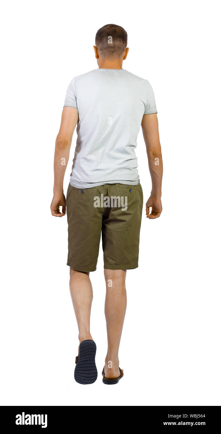Back view of going handsome man in shorts. walking young guy .backside ...