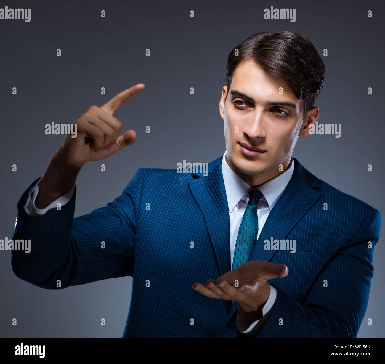 The businessman pressing virtual buttons on gray background Stock Photo ...