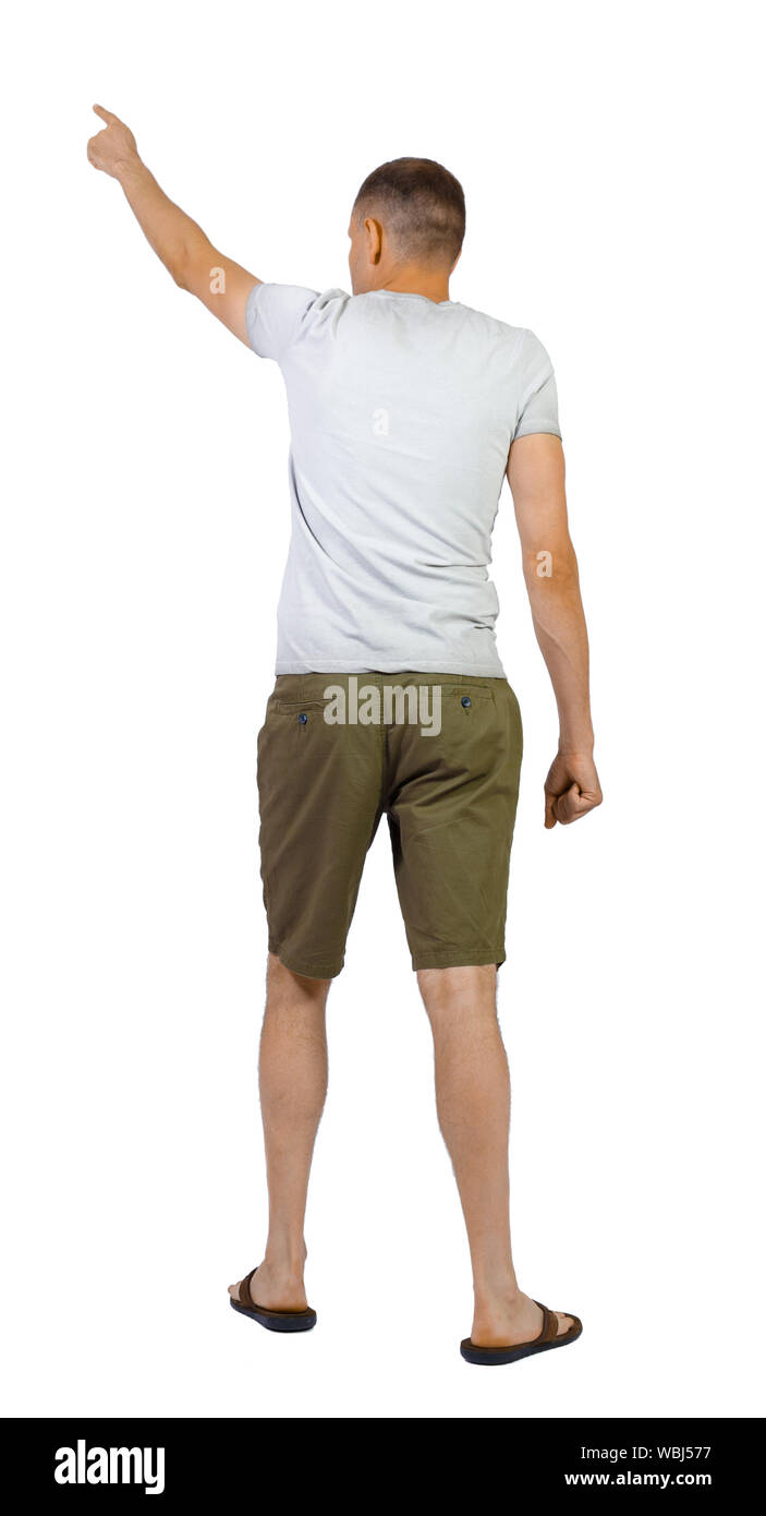 Back view of going handsome man in shorts pointing. walking young guy ...