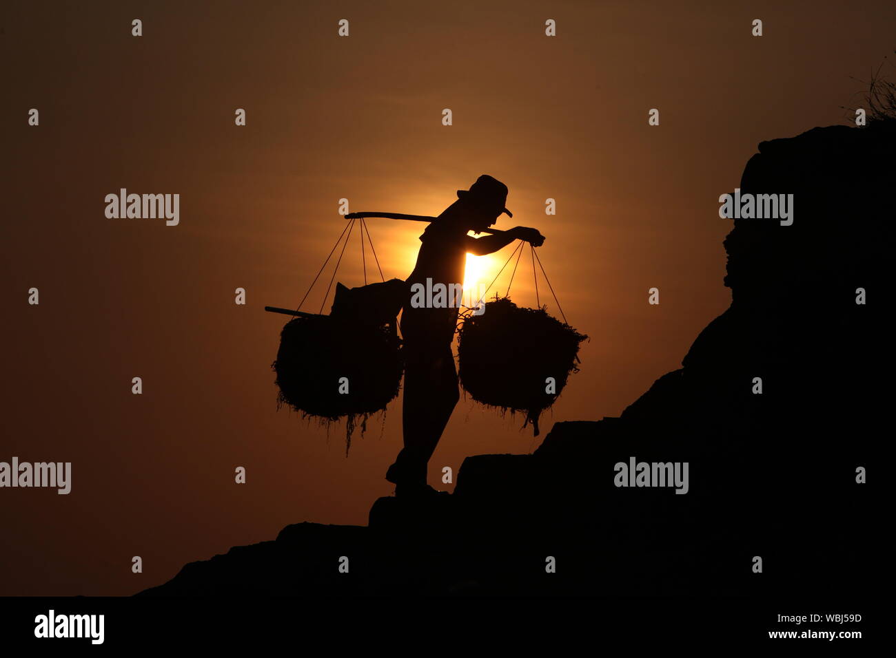 Man carrying baskets on shoulder High Resolution Stock Photography and ...