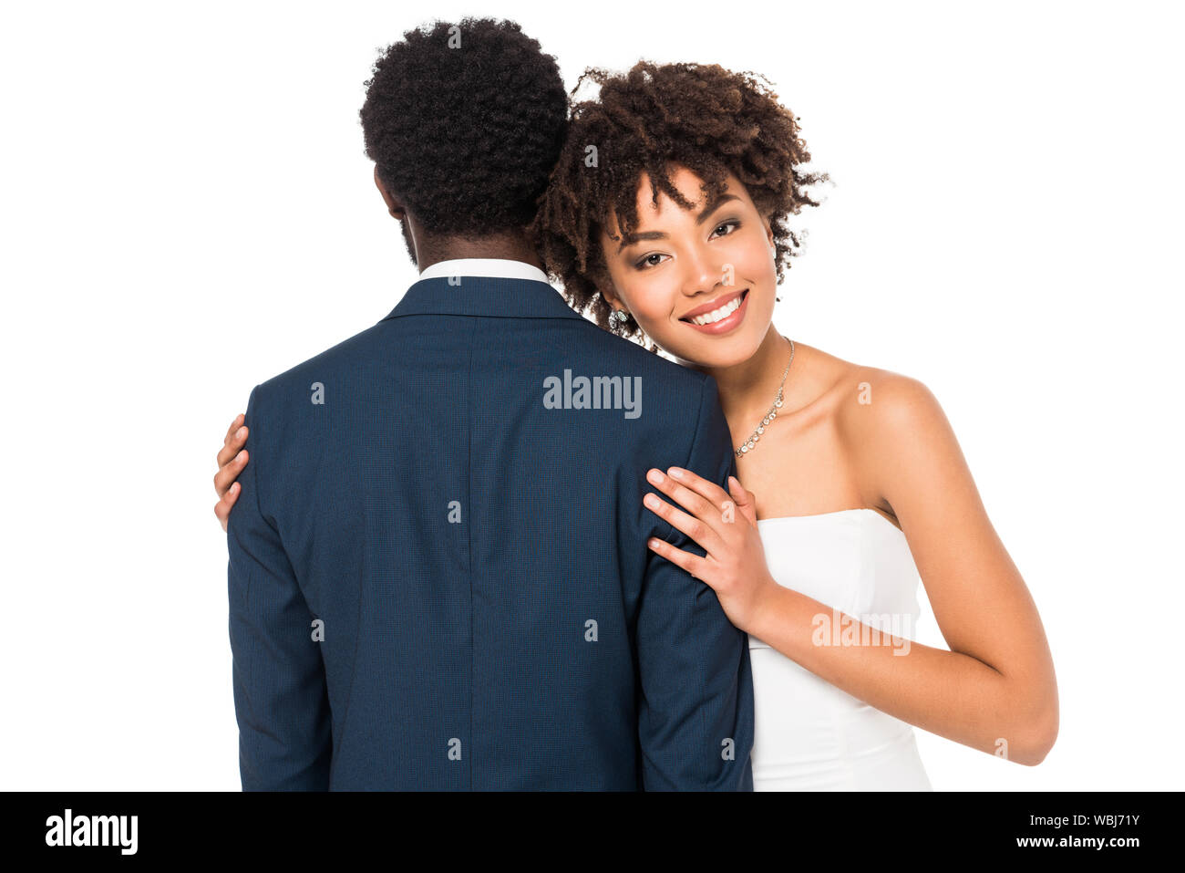 back view of african american bridegroom standing with happy bride ...