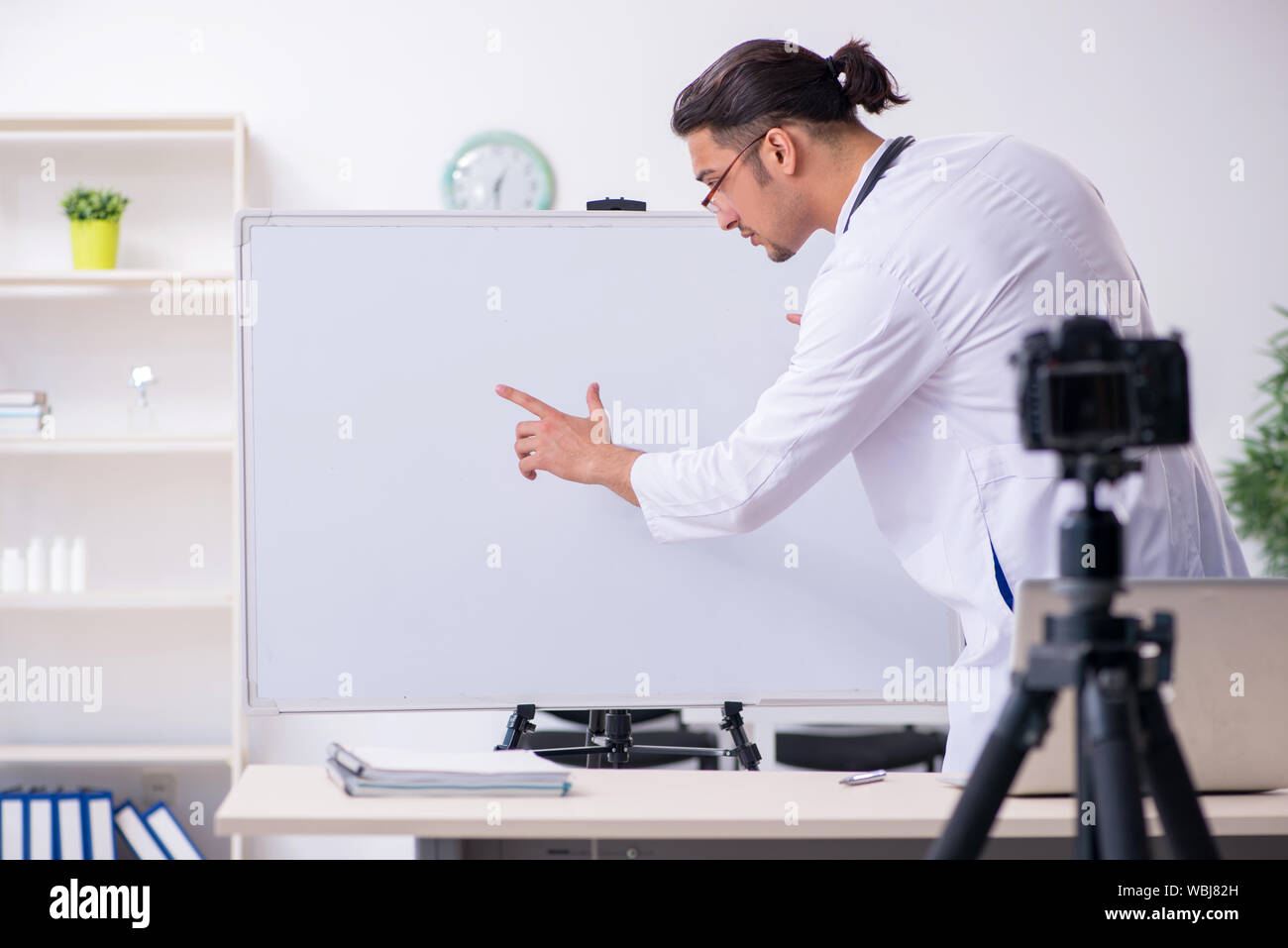 The young male doctor recording video for his blog Stock Photo - Alamy