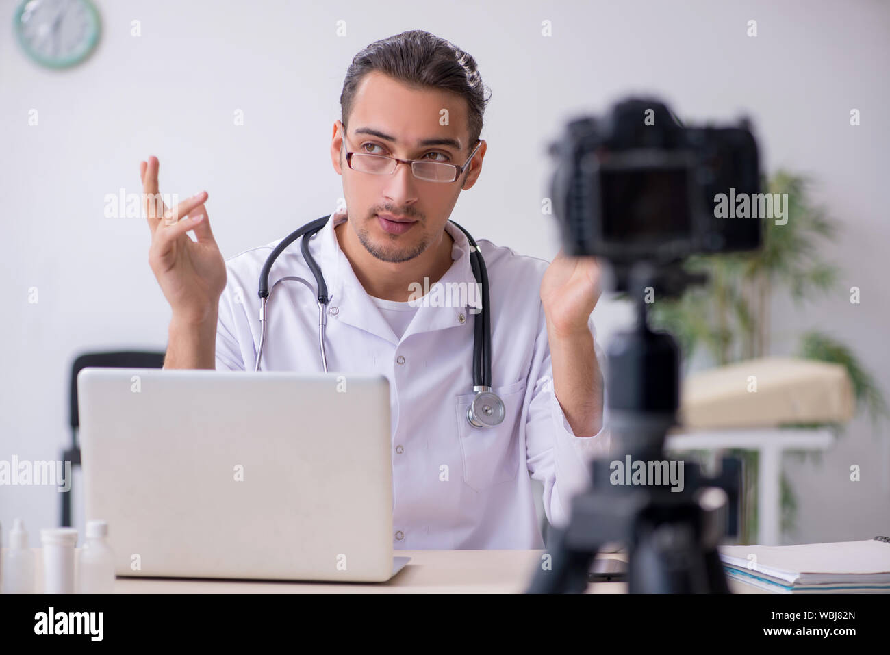 The young male doctor recording video for his blog Stock Photo - Alamy