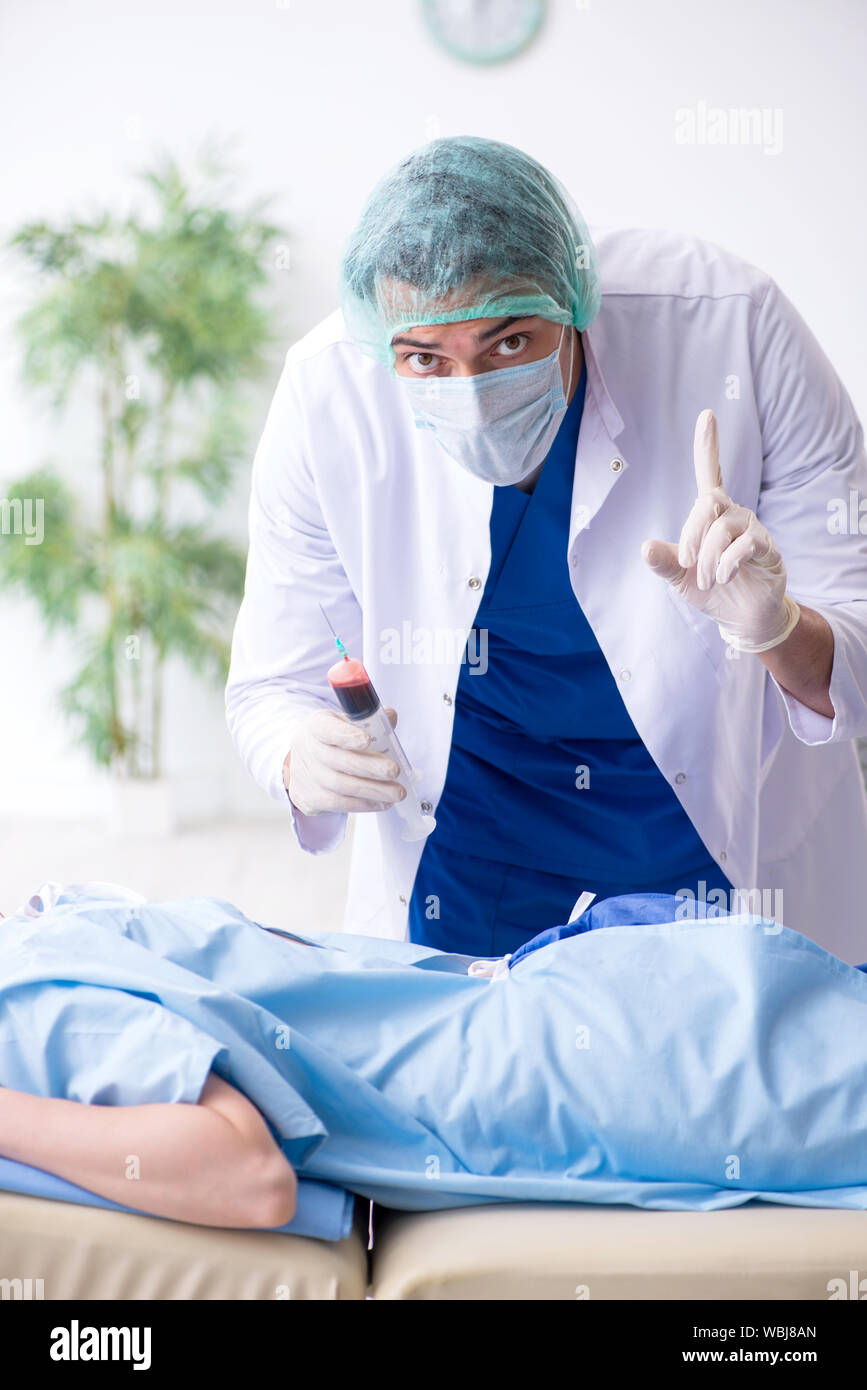 The female patient getting an injection in the clinic Stock Photo - Alamy