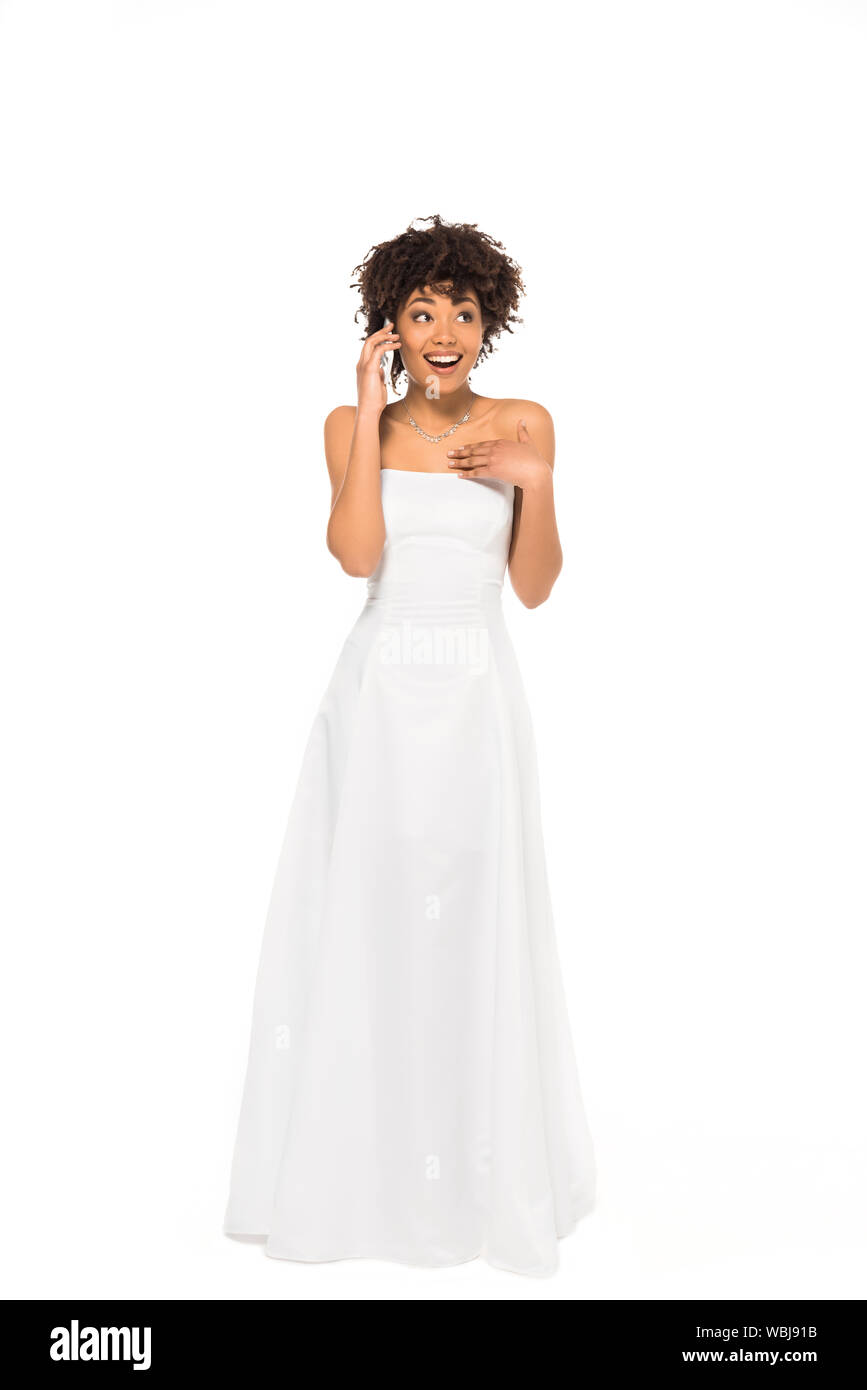 excited african american bride standing and talking on smartphone ...