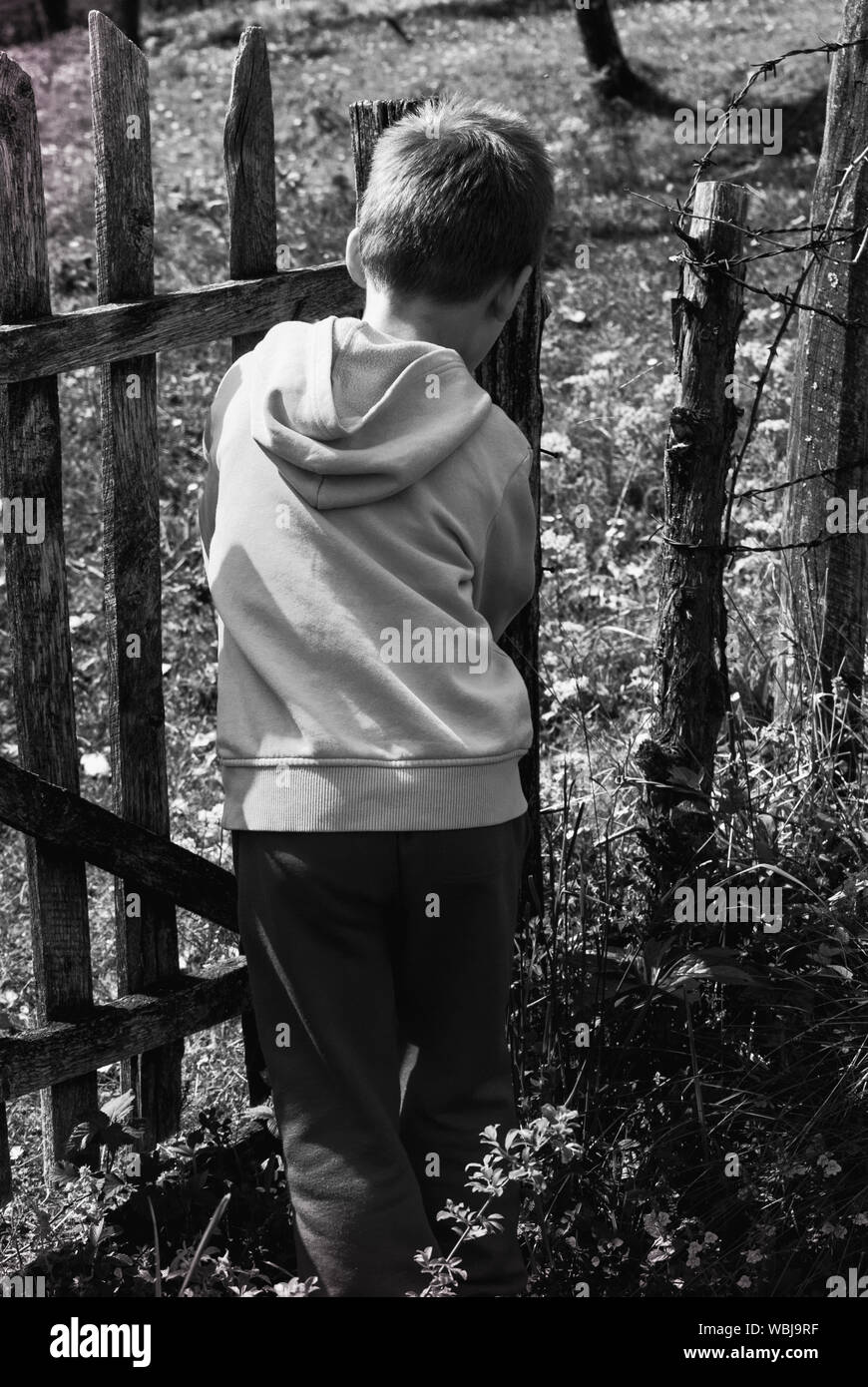 Boy standing rear view hi-res stock photography and images - Alamy