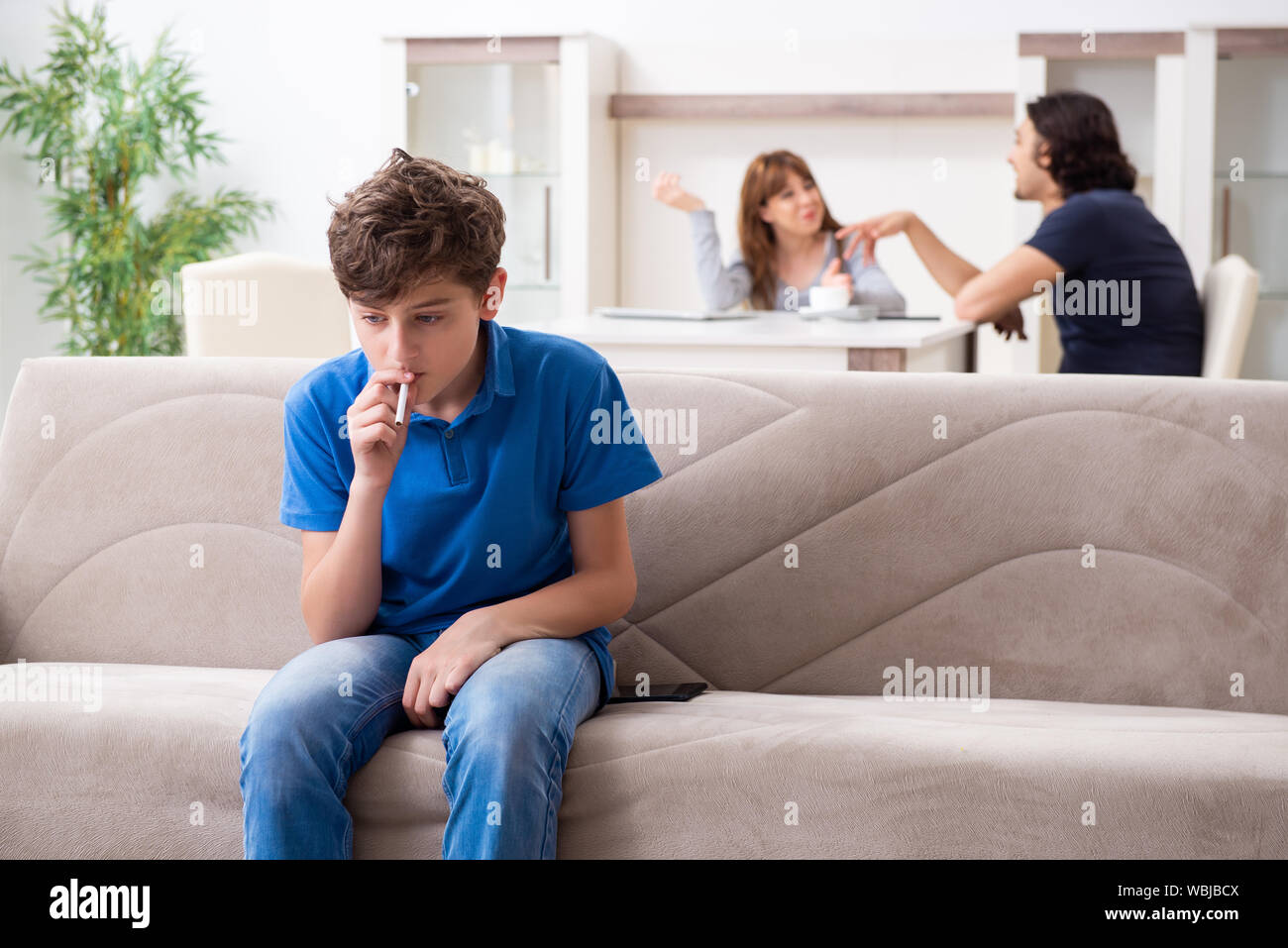 The concept of underage smoking with young boy and family Stock Photo ...
