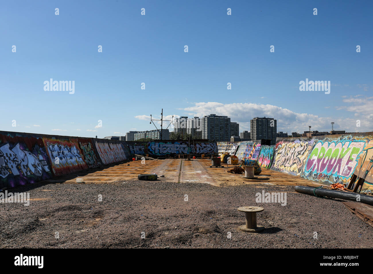 Large barge, covered with graffitis, Merihaka district in background in ...