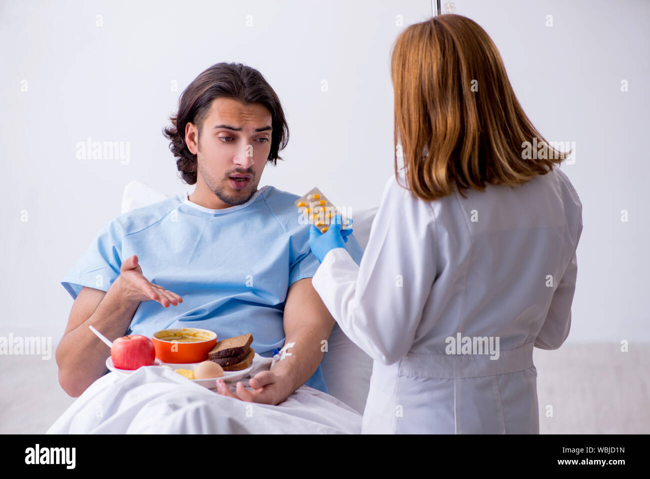 The male patient eating food in the hospital Stock Photo - Alamy
