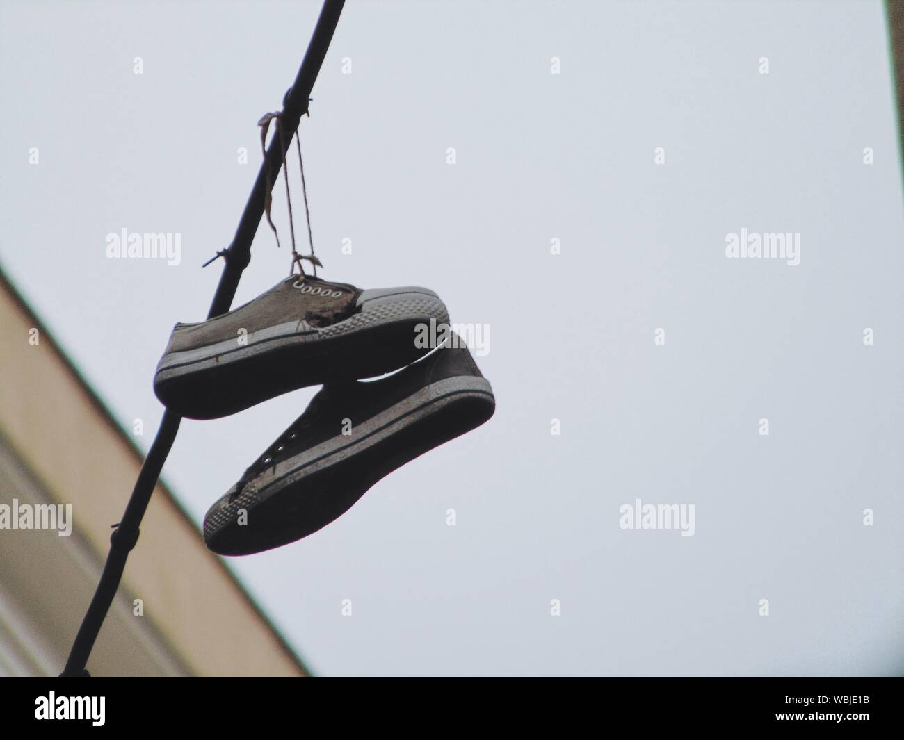 Shoes hanging from power line hi-res stock photography and images - Alamy
