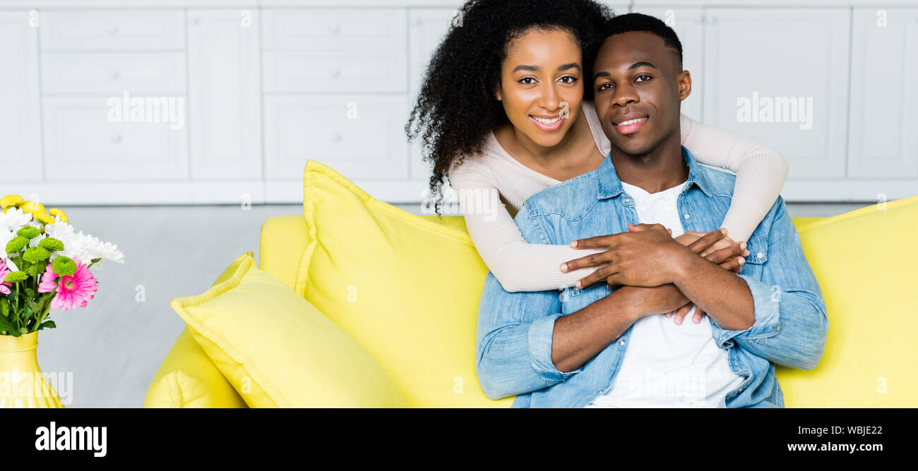 African American Couple Hugging Each Other And Looking At Camera Stock