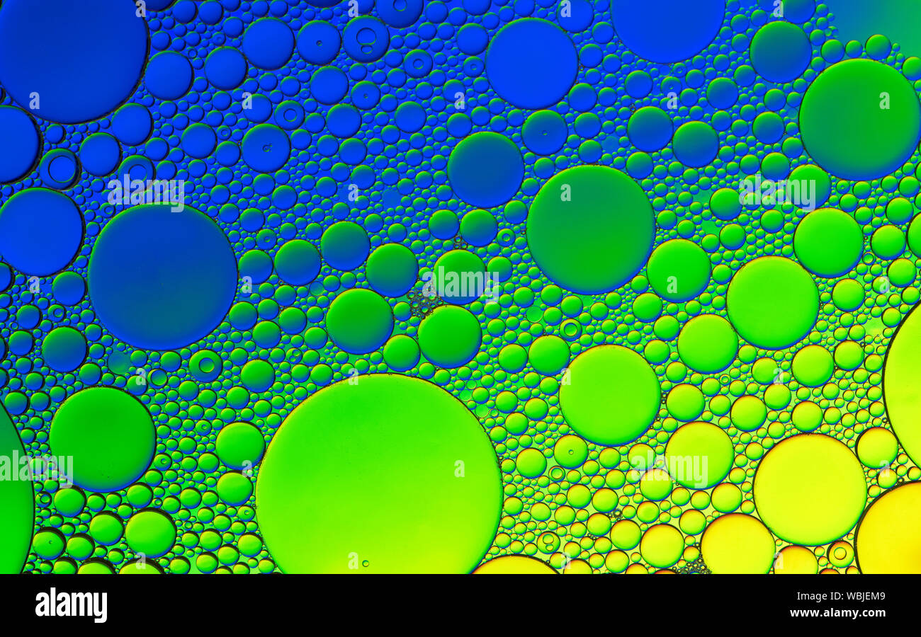 Multi-coloured bubble patterns formed by oil floating on water Stock ...