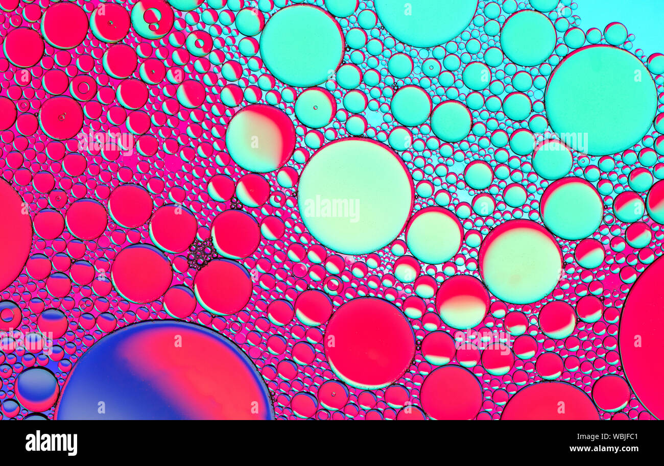 Multi-coloured bubble patterns formed by oil floating on water Stock ...