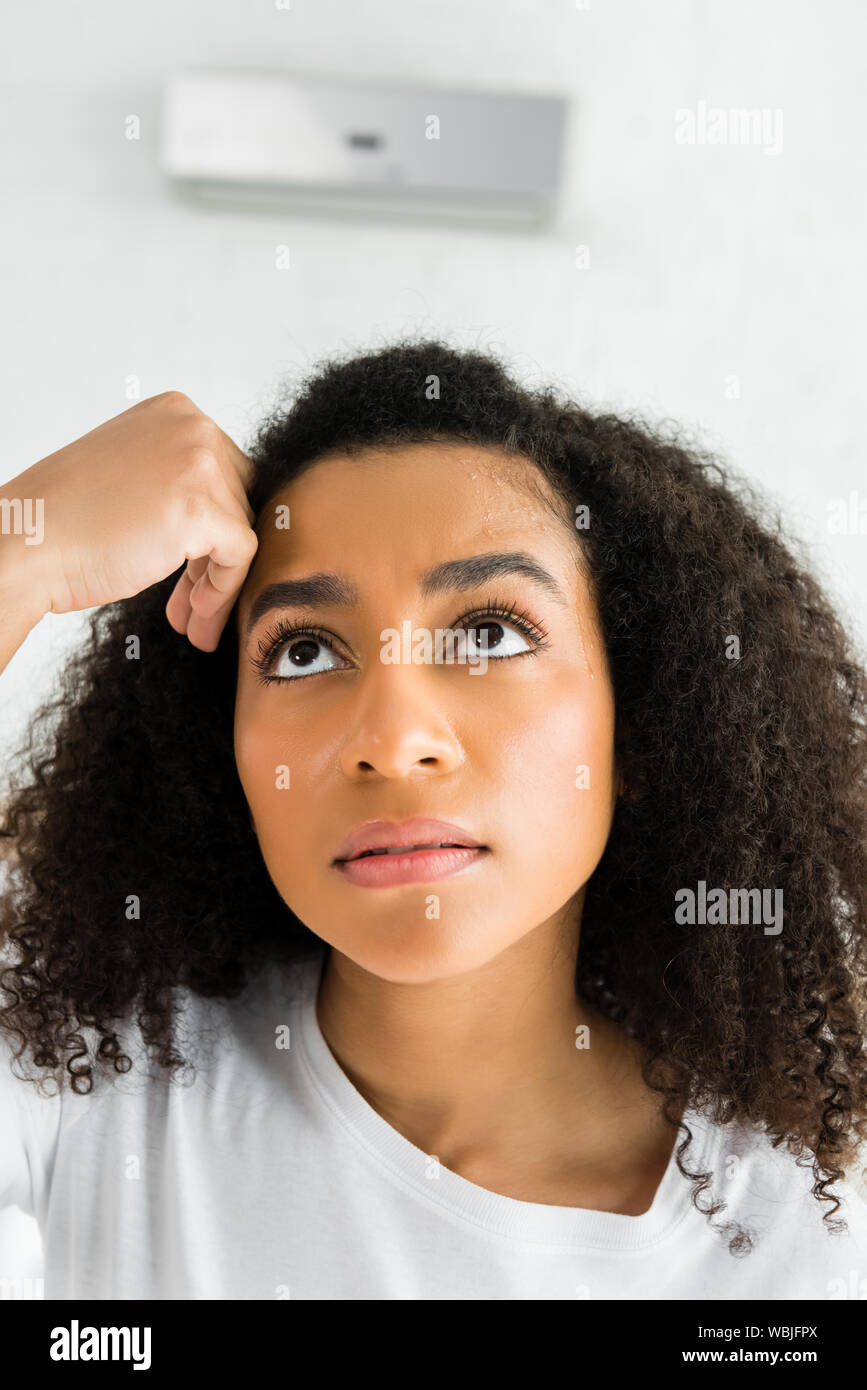 portrait of upset african american woman looking away and standing in ...