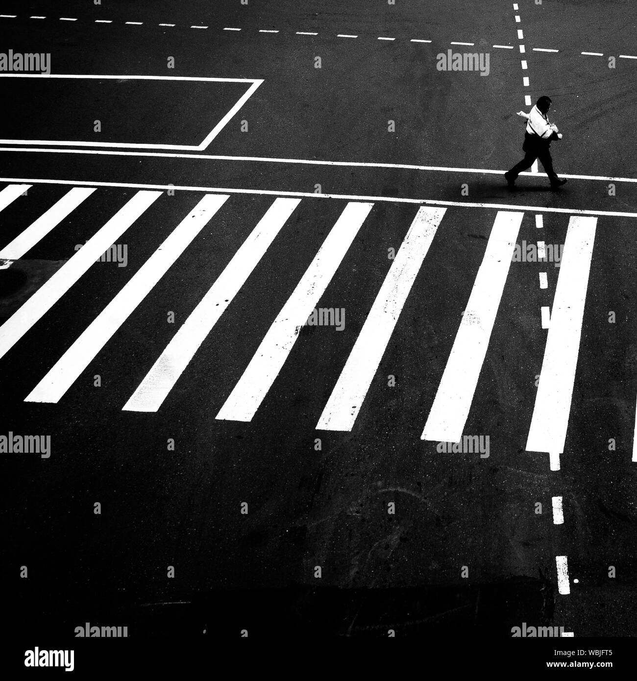 Man crossing road crossing Black and White Stock Photos & Images - Alamy
