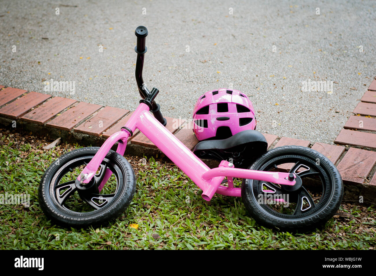 Pink bike for little girl. A pink bike parking in the park near the ...