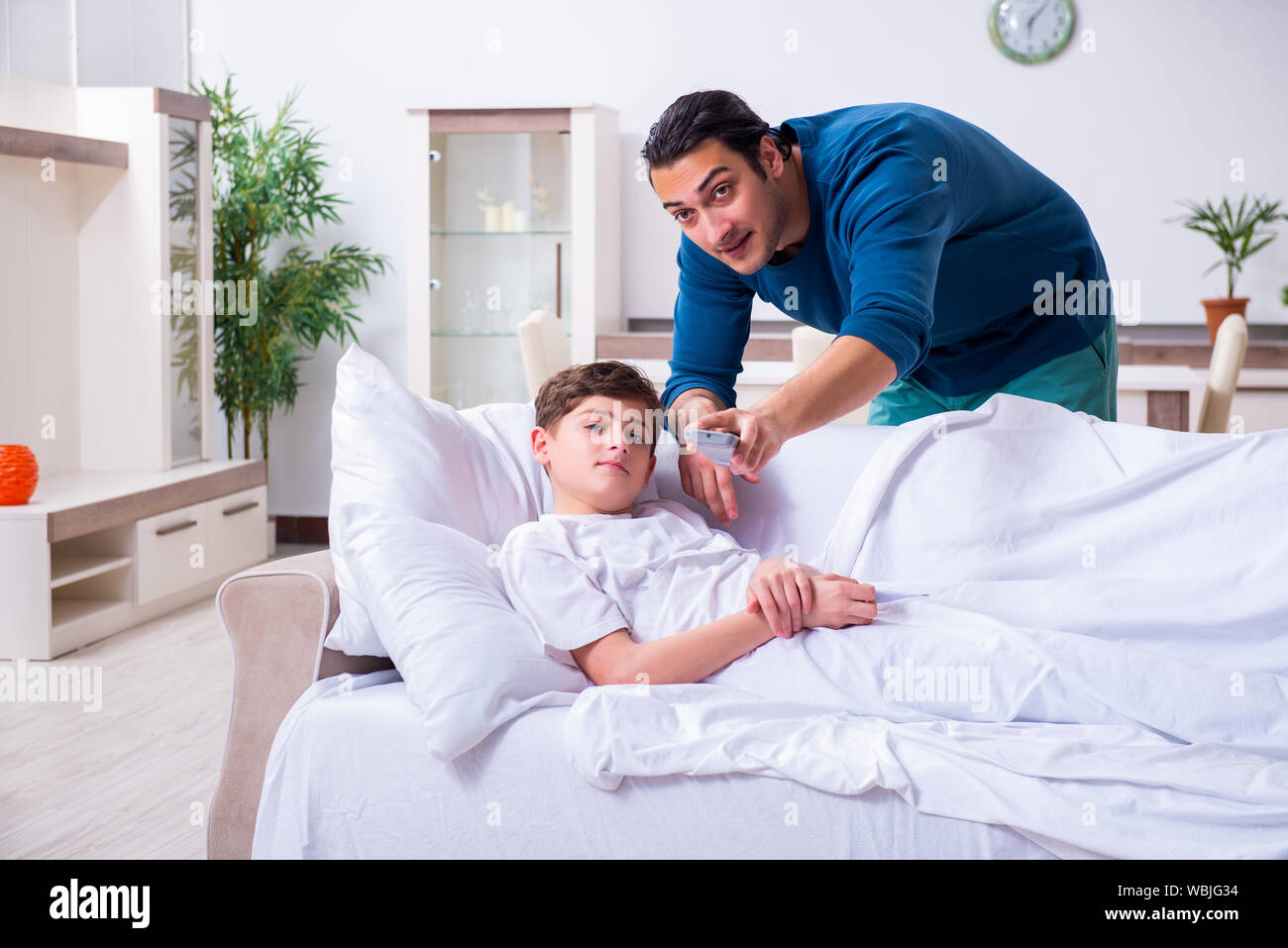 The young father caring for sick son Stock Photo - Alamy